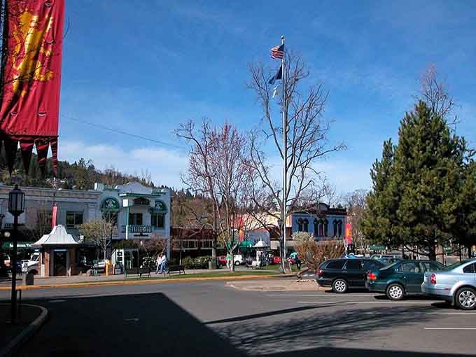 The town square's colorful buildings and mountain backdrop create a scene worthy of any European travel magazine cover shot.