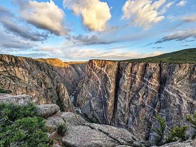 Golden hour illuminates the canyon's ancient walls, revealing layers of geological history in dramatic shadow and light.