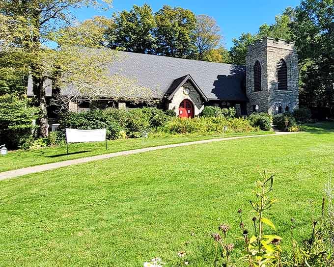 That red door and stone tower rising from lush gardens could be straight from an English countryside postcard.