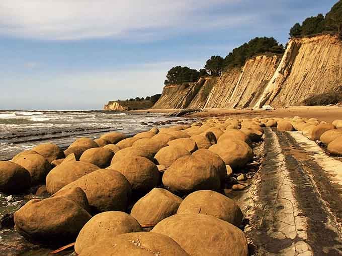 Round boulders line up in perfect rows like a giant's bowling alley abandoned at low tide.