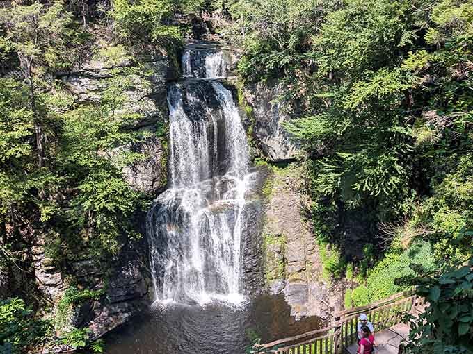 Water cascades down layered rock in silky ribbons—nature's own fountain show, complete with cool mist and rainbows.