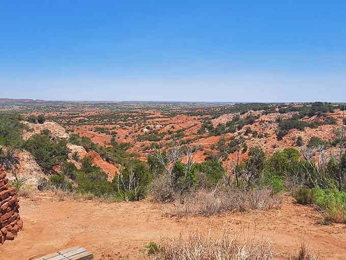 Red canyon walls stretch endlessly under blue skies, painting a landscape that rivals anything you've seen in Western movies.