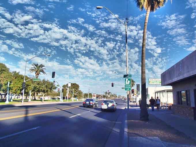 Palm trees sway along broad avenues where clouds paint masterpieces across Arizona's famously photogenic sky every single afternoon.
