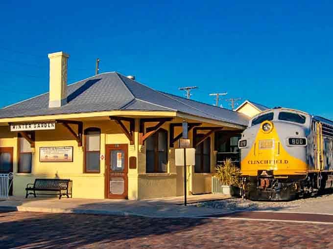This cheerful yellow depot sits beside vintage locomotives, preserving the golden age when trains ruled American travel.