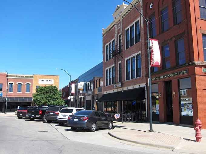 The Chamber of Commerce building anchors this downtown corner, where brick facades meet blue sky in perfect Midwestern harmony.
