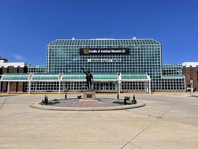The grand glass conservatory houses aviation history under soaring ceilings designed to accommodate dreams of human flight.