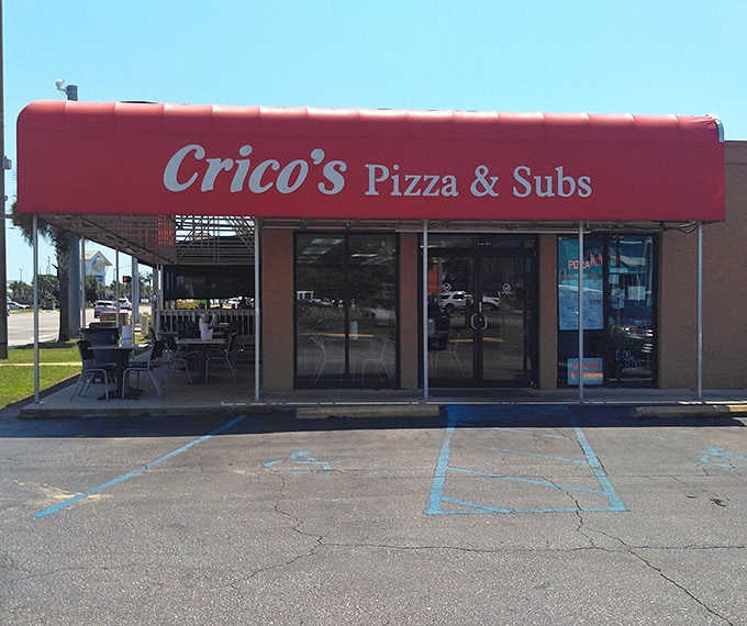 That bright red awning beckons beach-goers and locals alike to discover pizza that won't drain their vacation fund.