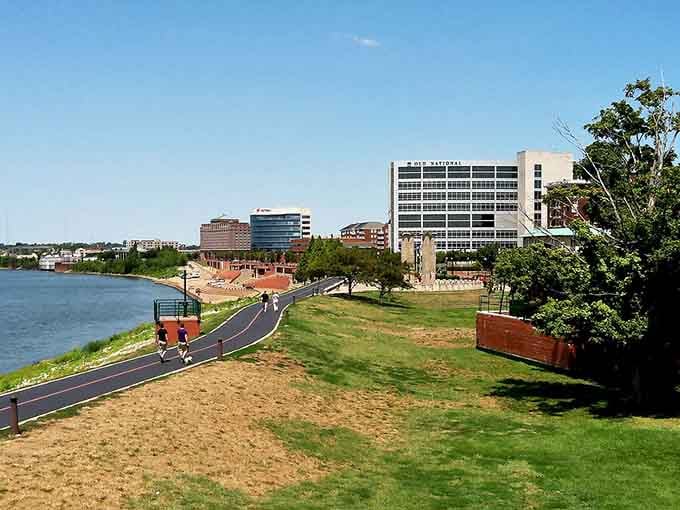 The riverfront path curves along green spaces where exercise costs nothing but a little effort and good shoes.