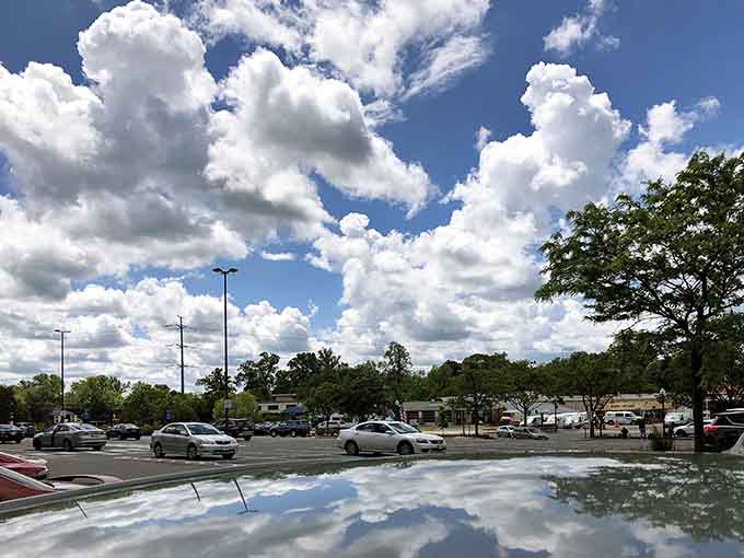 Those dramatic clouds reflected in puddles turn an ordinary parking lot into an accidental work of art.