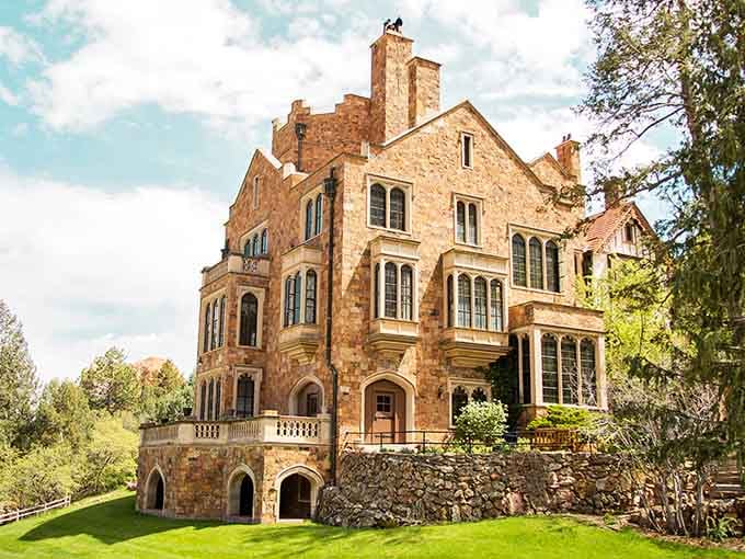 English Tudor stonework glows warmly in the sunlight, proving castles belong in Colorado just as much as anywhere.