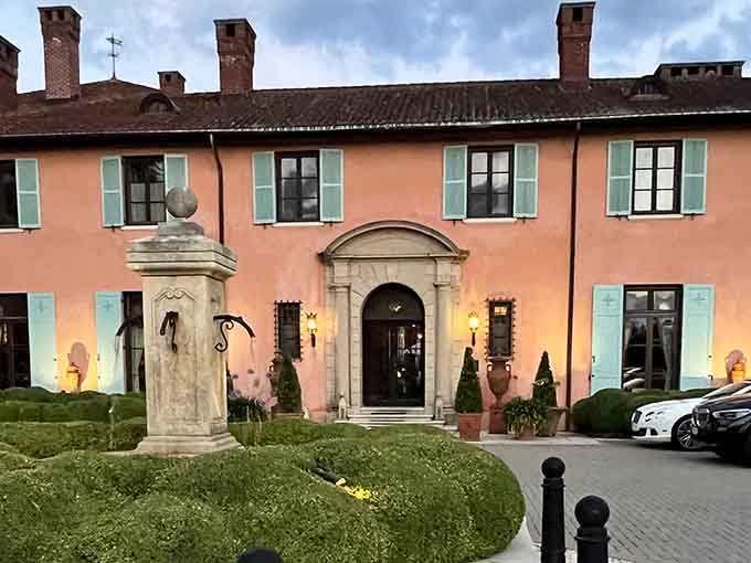 That peachy-pink facade with turquoise shutters looks like Tuscany decided to vacation in New York and never went home.