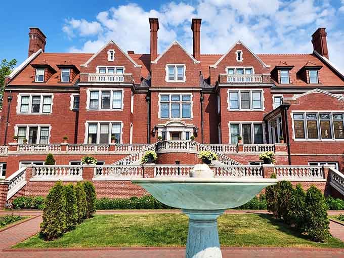 This Jacobean masterpiece commands its lakeside perch with aristocratic confidence, all red brick and white balustrades screaming old money.