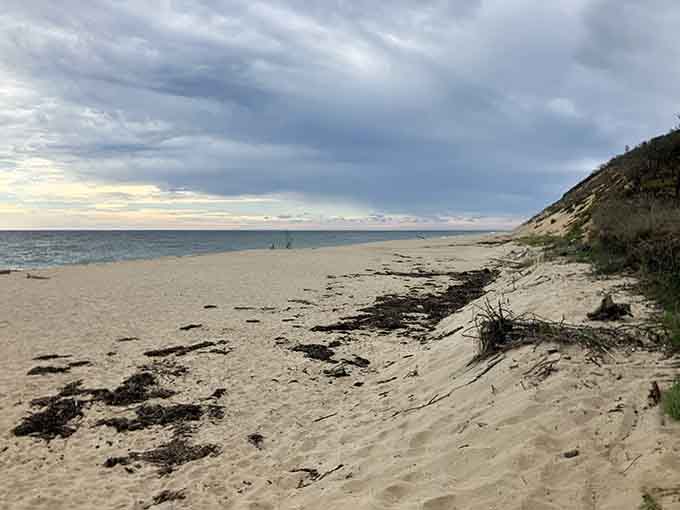 The wild Atlantic coastline stretches endlessly where sand dunes meet the sea in timeless, windswept beauty.