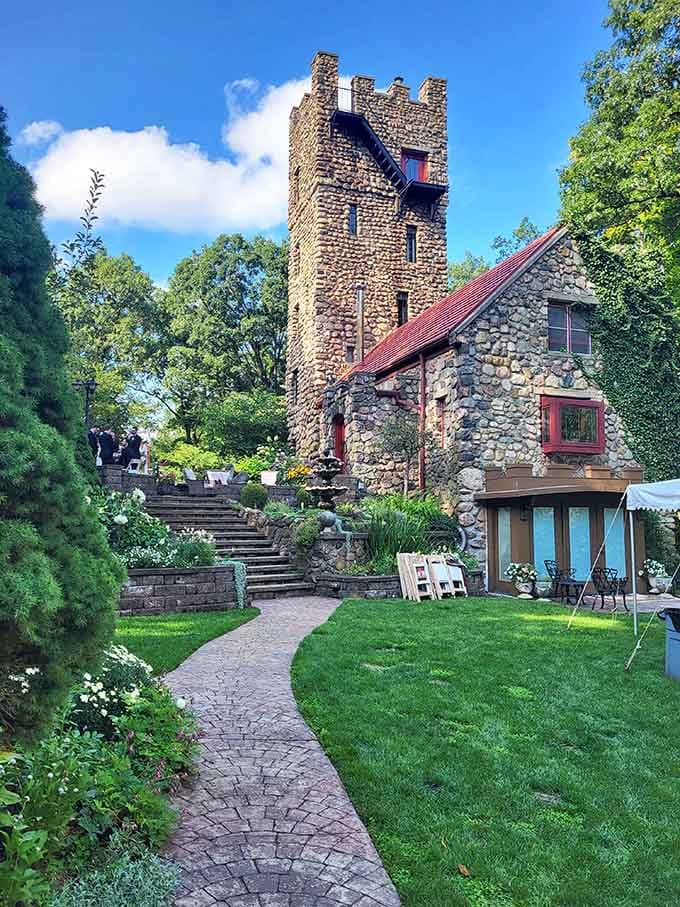 A stone tower reaches skyward beside the main house, wrapped in ivy like something from a Grimm tale.