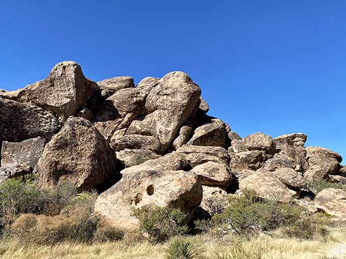 These massive rock formations rise from the desert floor like ancient sculptures, weathered by time and wind.