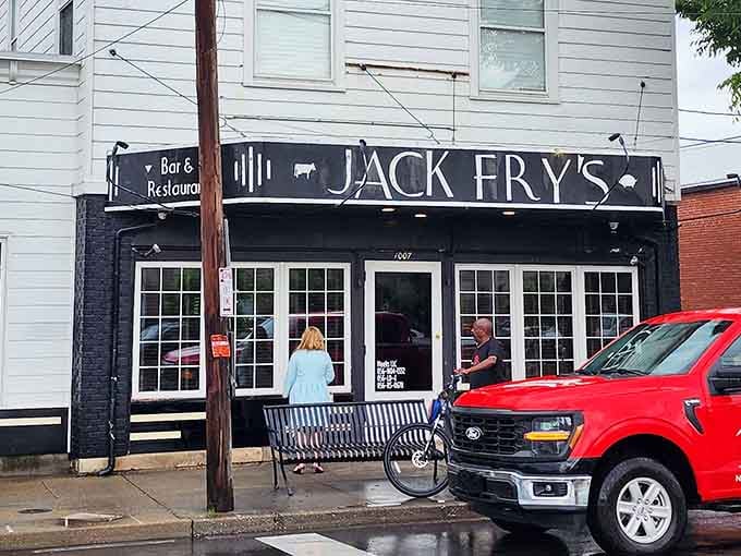 Classic black and white exterior design creates timeless elegance on this charming Louisville neighborhood street corner.
