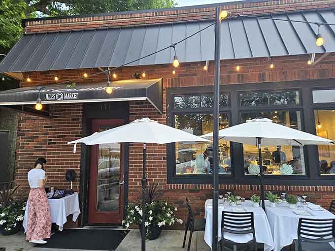 String lights and white umbrellas create magic at dusk, transforming dinner into an enchanting evening under the stars.