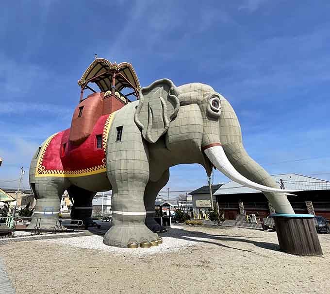 Lucy stands tall and proud, her decorative howdah gleaming—because nothing says "roadside Americana" like climbing inside an elephant.
