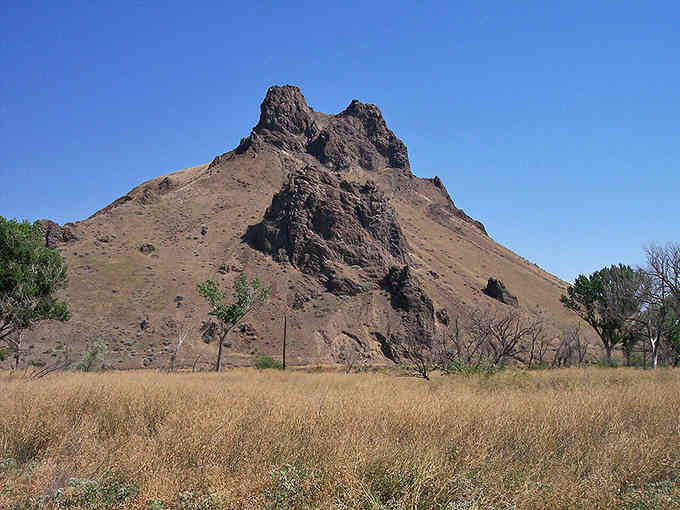 Rising from the flat eastern Oregon landscape like nature's own monument, this volcanic remnant commands attention from every direction for miles.