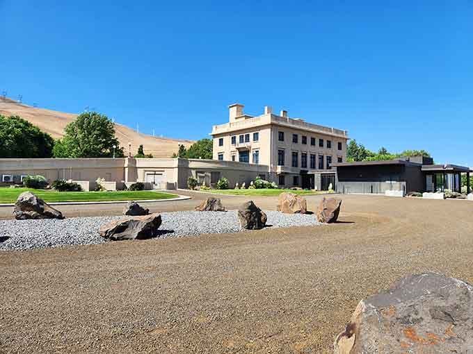 The grand architecture stands proudly against golden hills, blending European elegance with Washington's rugged landscape beautifully.