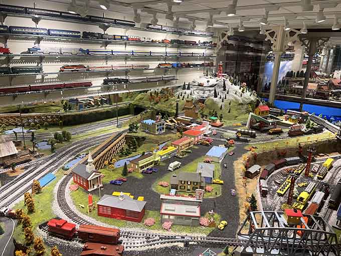 Miniature trains circle through perfectly detailed landscapes where tiny people live their best lives in HO scale perfection.