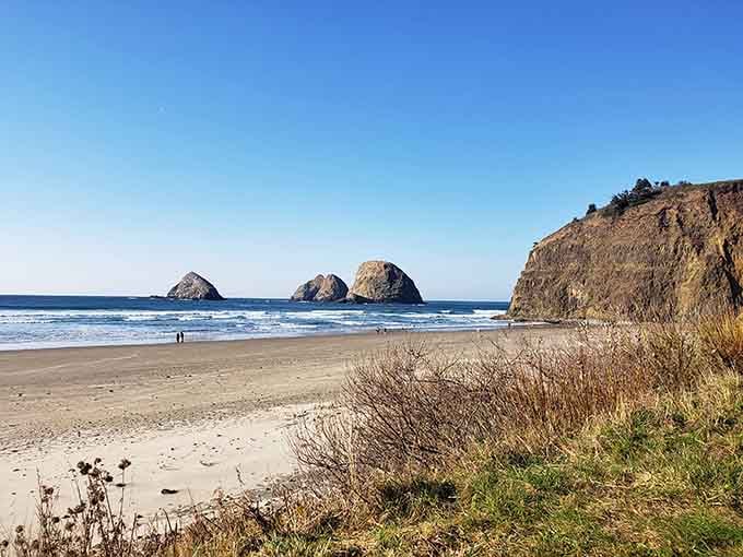 Three rounded sea stacks line up offshore like nature's bowling pins waiting for some mythical giant's turn.