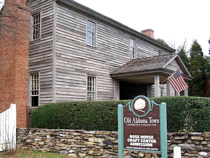The Rose House stands proudly behind its stone wall, a testament to simpler times and craftsmanship.