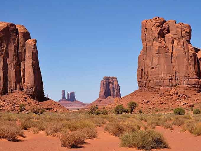 Monument Valley's towering buttes frame the desert like nature's own cathedral, humbling and magnificent all at once.