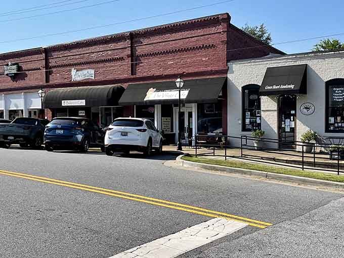 The detailed brickwork and black awnings give these shops a sophistication that never goes out of style.