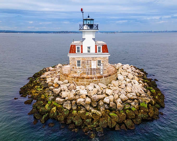 Perched on its rocky island throne, this red-roofed beauty looks like a dollhouse for very brave souls.