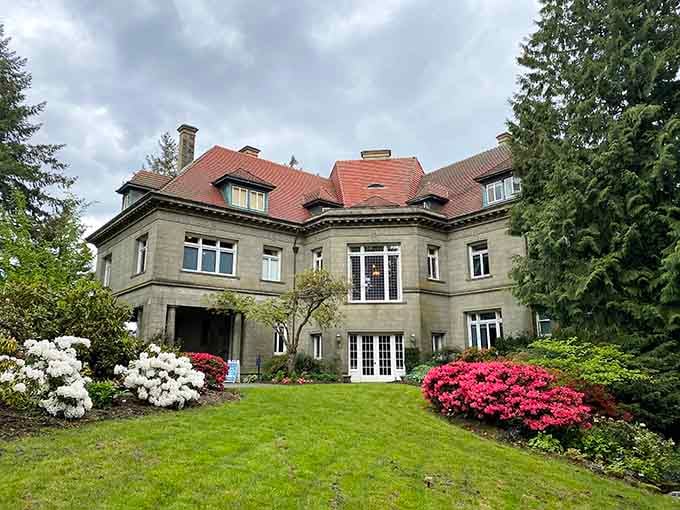 Red-tiled roof and blooming azaleas frame this elegant mansion like something from Downton Abbey, only with better views.