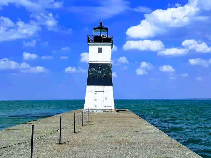 This classic lighthouse stands guard where Lake Erie meets the shore, a beacon that's guided sailors through countless sunsets and storms.