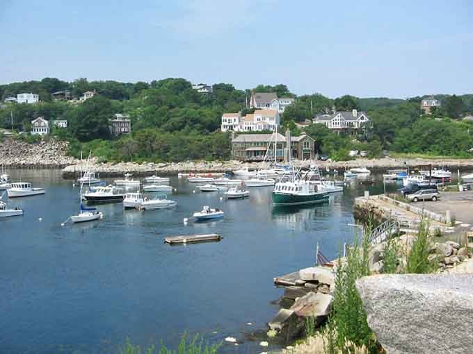 Pristine harbor waters reflect colorful homes perched on hillsides, creating postcard views that never get old no matter how often you see them.