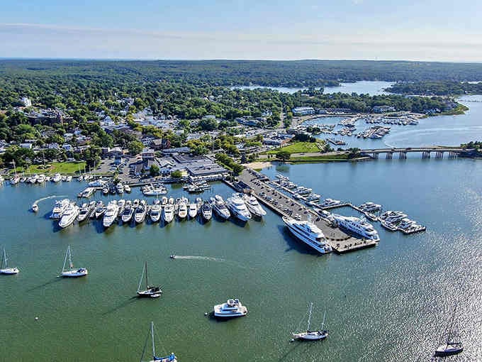 Boats fill the harbor like a floating parking lot, while the blue water stretches toward horizons that promise endless summer days.
