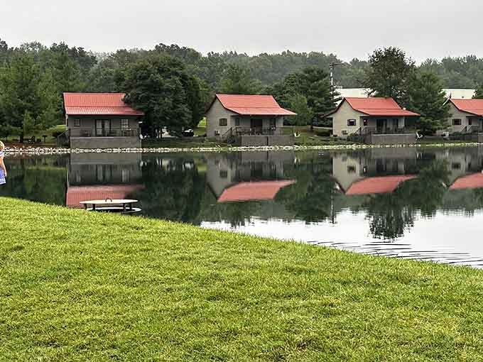 Those red-roofed cabins reflecting in the glassy water create a scene so perfect it almost looks painted on.