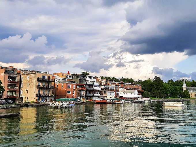 Dramatic clouds hover over waterfront homes creating a scene worthy of any classic American painting or postcard.