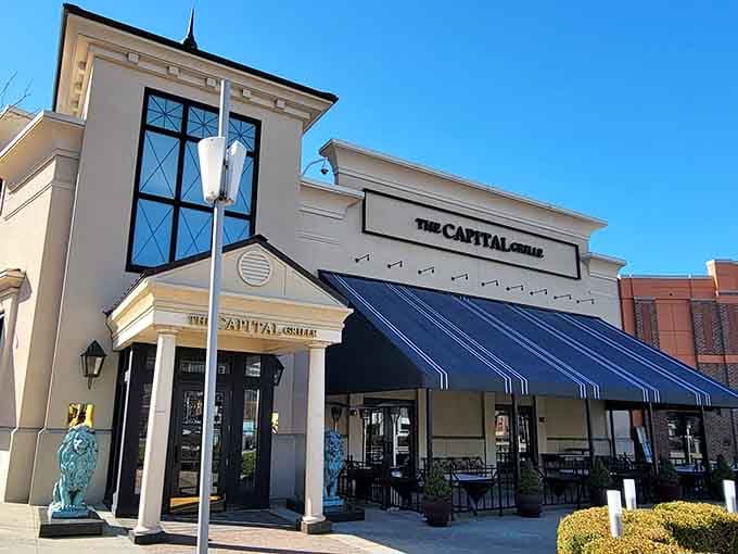 Those navy awnings and pristine white columns give off serious country club elegance without any stuffiness whatsoever.