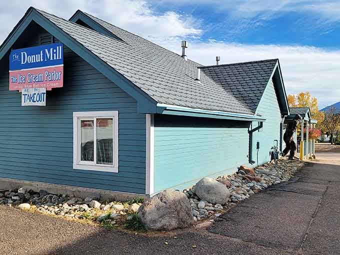 This blue cottage with white trim looks like it wandered out of a fairy tale and decided to sell donuts.