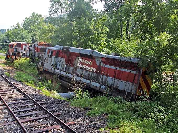 Weathered locomotives rest at dramatic angles where Hollywood left them, now serving as nature's most unusual outdoor sculpture garden.