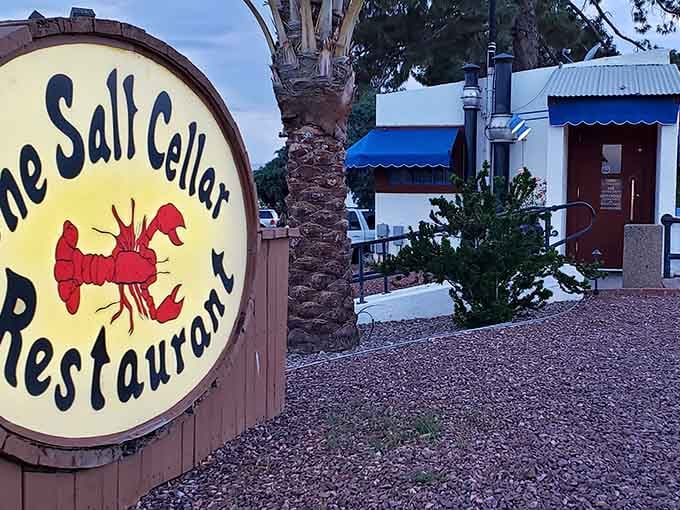 That cheerful lobster sign marks the spot where you descend underground for fresh seafood in a cozy, cave-like setting.