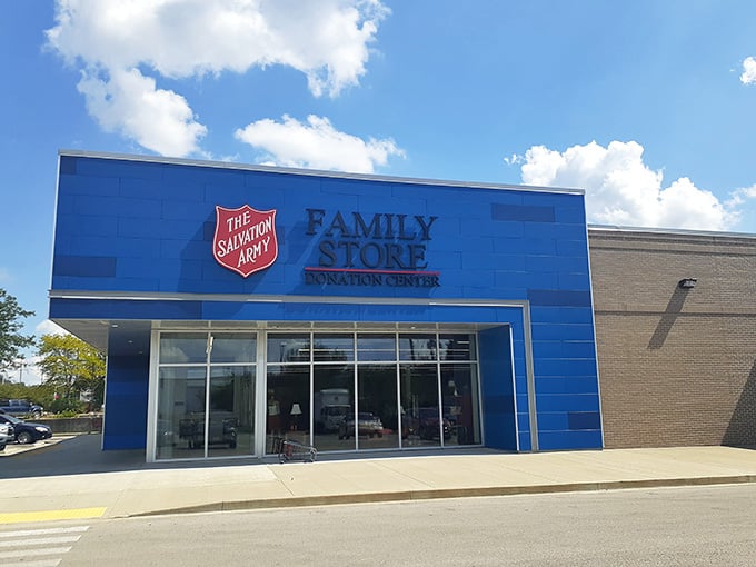 That iconic blue Salvation Army storefront stands proud under puffy clouds, a beacon for budget-conscious shoppers everywhere.