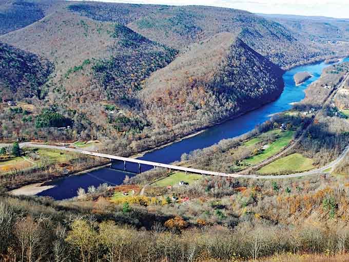 The river bends dramatically through forested mountains, creating a horseshoe of pure Pennsylvania wilderness from above.
