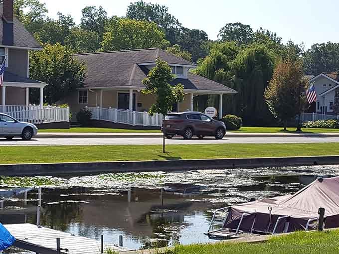 Lakeside homes with manicured lawns reflect perfectly in calm waters, creating double the beauty for your eyes.