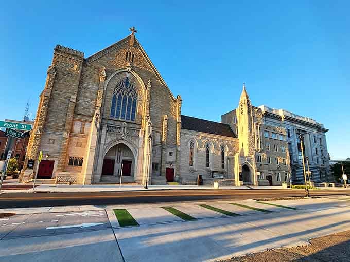 Golden light bathes this Gothic cathedral's stonework, making evening walks feel like stepping into a European postcard somehow.