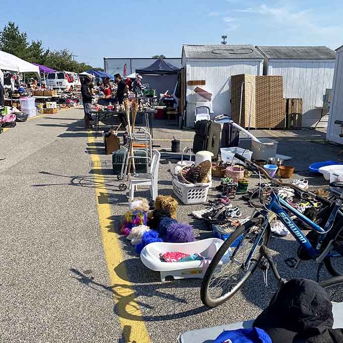 A vintage bicycle rests among scattered finds, adding character to this sprawling outdoor marketplace under perfect skies.