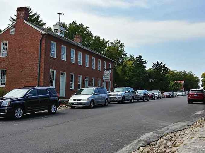 Cars line the street outside this historic building where people clearly know something good is happening inside those brick walls.