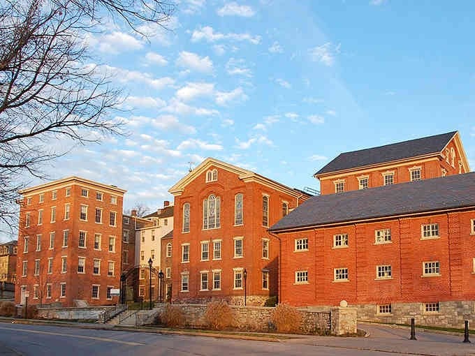Historic brick buildings glow warm in sunset light, showing off craftsmanship that modern construction just can't match.