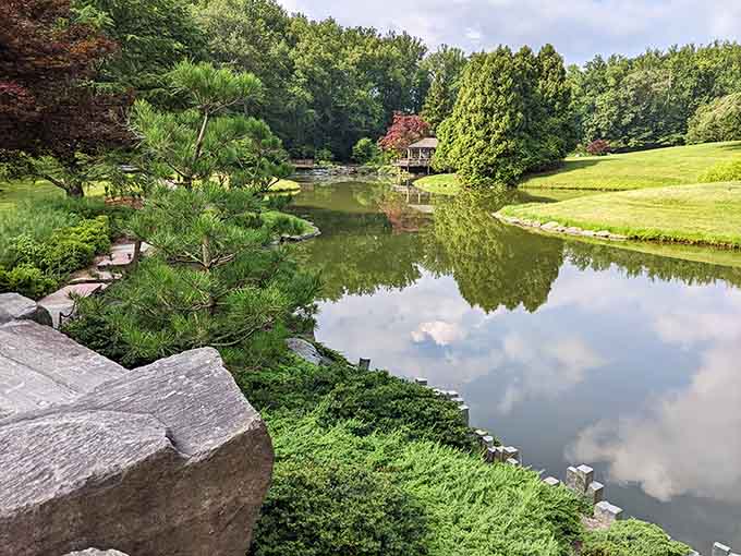 The pond mirrors clouds and trees so perfectly, you'll wonder which side is real and which is reflection.