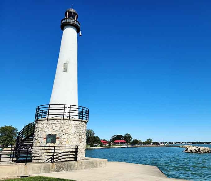 The classic lighthouse design rises gracefully from its sturdy foundation, inviting visitors to explore the harbor.