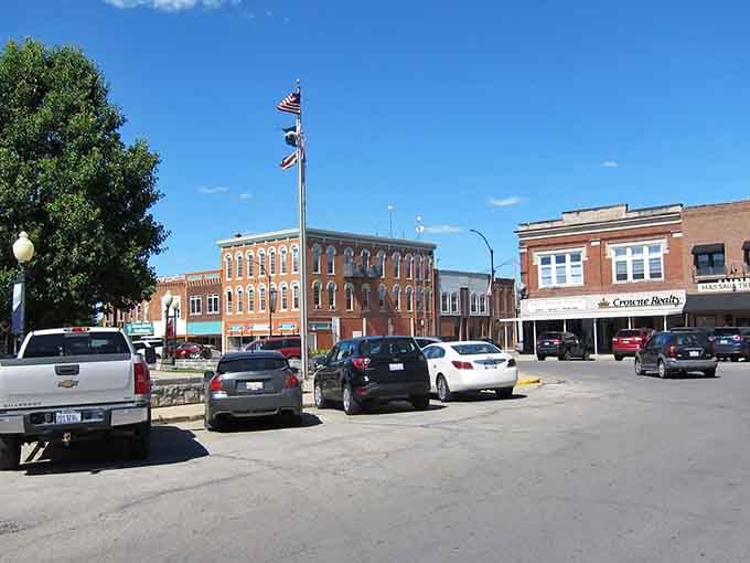 American flags flutter above downtown streets lined with three-story buildings&mdash;patriotism and commerce living side by side since forever.